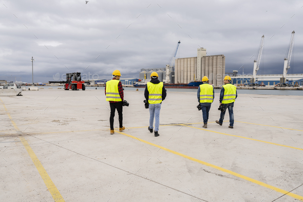Construction Workers Walking Towards Job Site at Port Stock Photo by ...