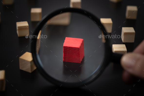 Magnifying glass to inspect a wood block in still life photography ...