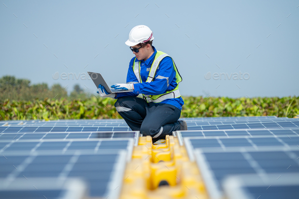 Solar Technician Monitoring Panels with Laptop Stock Photo by PICCOLINO208