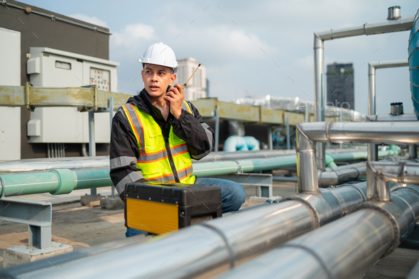 Technician Using Measuring Equipment on Industrial Pipes Stock Photo by ...