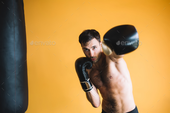 Strong male boxer standing and practicing in gym Stock Photo by GaudiLab