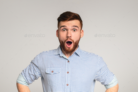 Surprised man with shocked look on studio background Stock Photo by ...