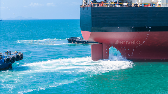 Propeller of large ship spinning power working and water splash ...