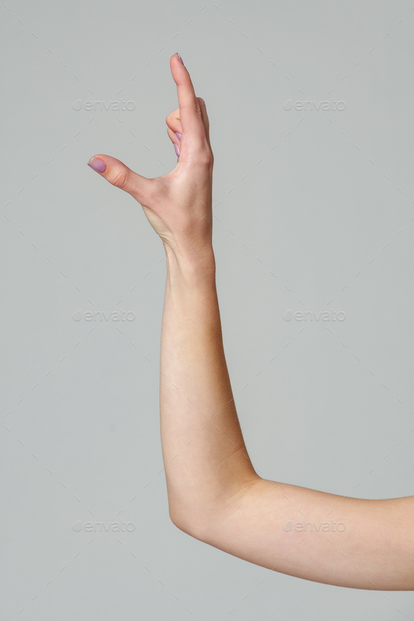 Female hand sign against gray background in studio Stock Photo by ...