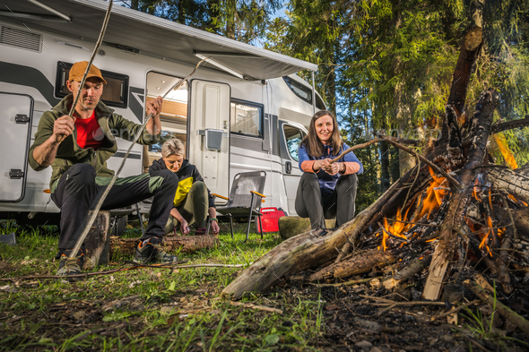 Family in Front of Campfire and Their Camper Van Stock Photo by duallogic
