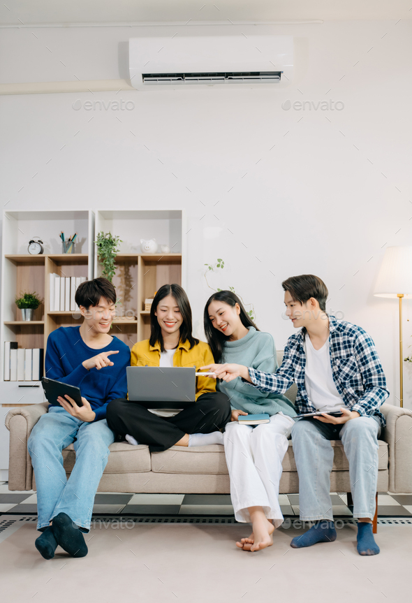 Group of young Asian college students working on his project assignment ...