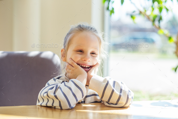Happy Little Kid Smiling with Hands on Face Stock Photo by OlhaRomaniuk