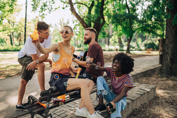 Group of hippies sitting in park and having fun on earth day. Stock ...