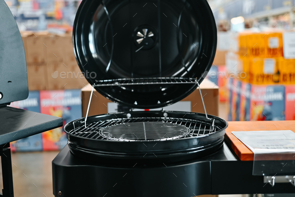 Selling black round barbecue grill in a store, front view Stock Photo ...