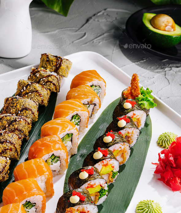 Assorted sushi platter on elegant white table Stock Photo by AntAlexStudio