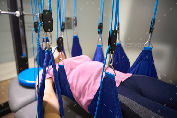 Blurred woman hanging on suspension medical ropes after injury during ...