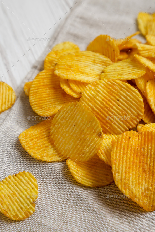 Ruffled Cheese Potato Chips, side view. Close-up. Stock Photo by LChuhunova