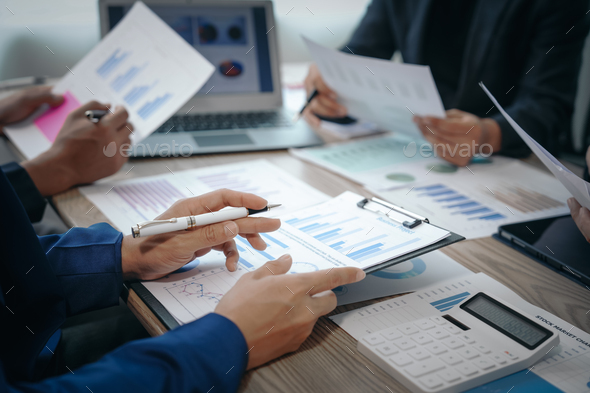 Professional business team meeting in formal suits, working at desks ...