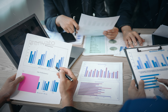 Professional business team meeting in formal suits, working at desks ...
