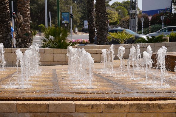 Splashing fountain water a park in city, row of fountains Stock Photo ...