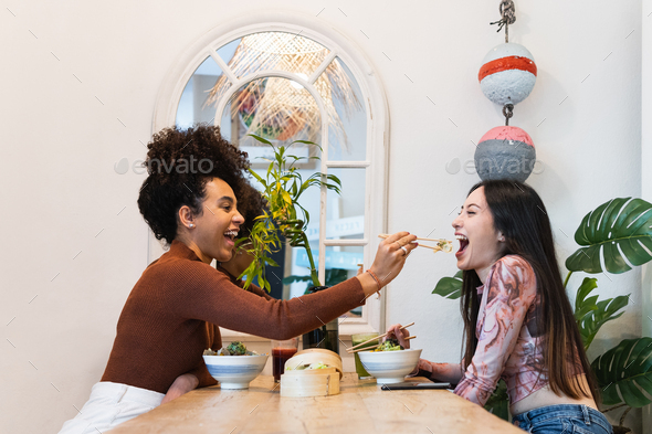 Friendly diverse women eating in restaurant together Stock Photo by ...