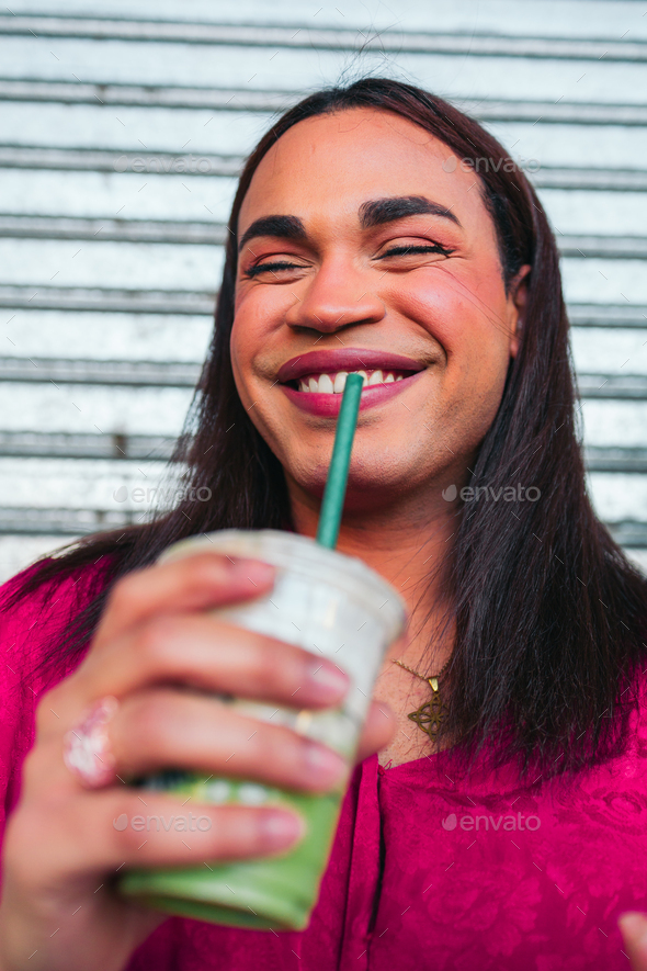 Trans woman of latin ethnicity drinking matcha. Headshot. LGBT people ...