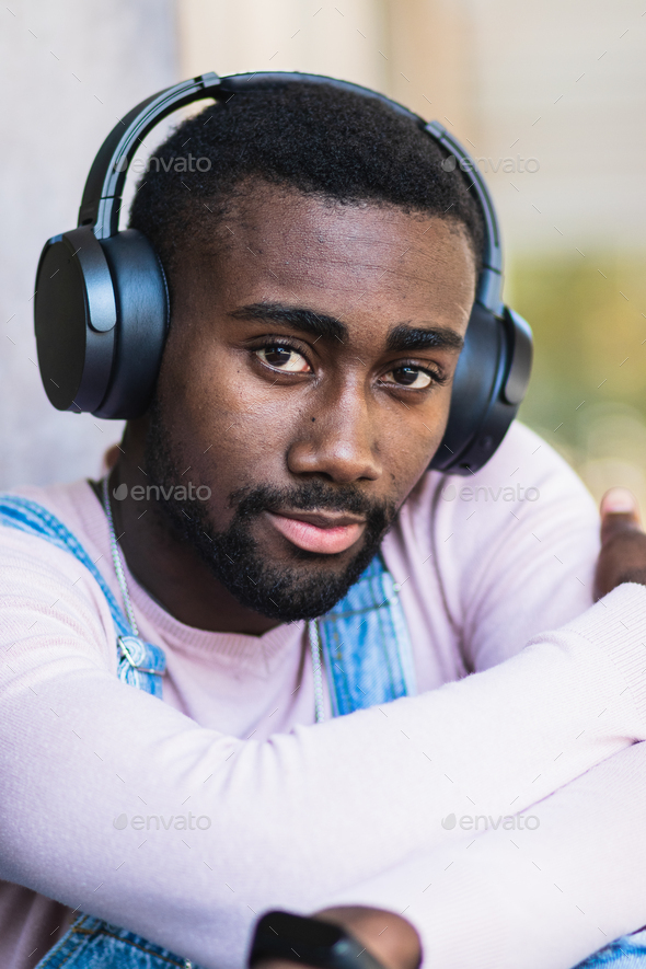 Stylish black man listening to music in headphones Stock Photo by ...