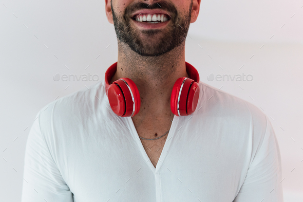Anonymous cheerful man listening to music white background Stock Photo ...