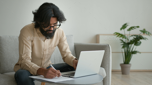 Arabian Indian muslim man guy businessman write notes papers paperwork ...