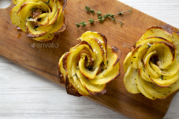 Homemade Potato Roses on a rustic wooden board, top view. Flat lay ...
