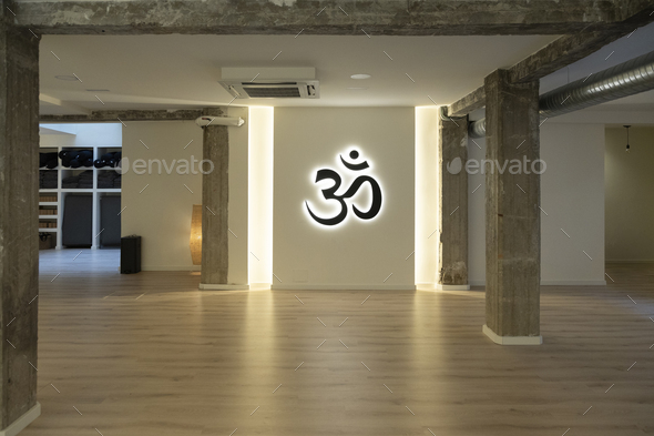 Spacious loft with Om symbol lighting and minimalist design. Stock ...