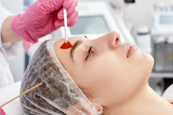 procedure of photoepilation in the beauty salon. Young Woman Receiving ...