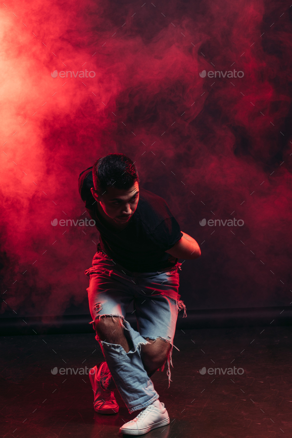 Single young man dancer wearing jeans showing various steps isolated in ...