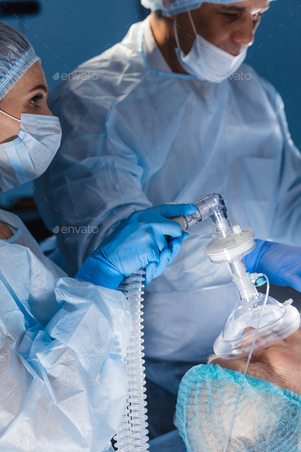 Medical Team Performing Surgical Operation in Bright Modern Operating ...