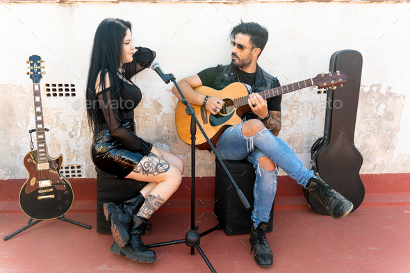 Guitarist and vocalist making music together Stock Photo by solerfotostock