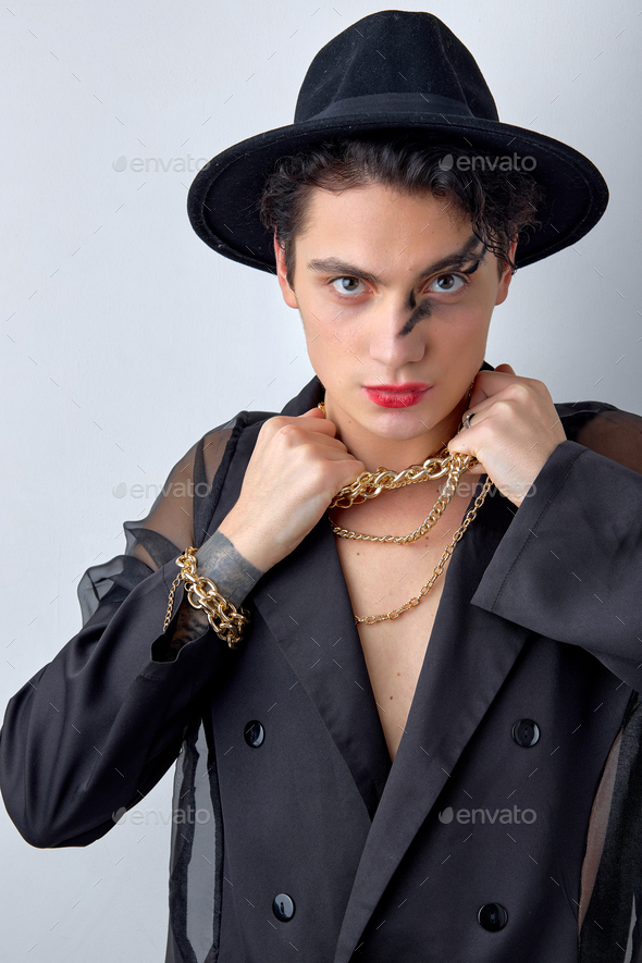 Serious young transgender man LGBTQ being as woman posing with chain ...