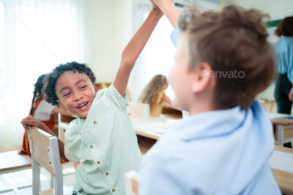 Students learn and study in a classroom of school where youngsters sit ...