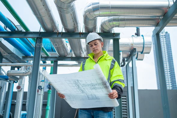 Engineer checking drawings on rooftop Stock Photo by PICCOLINO208 ...