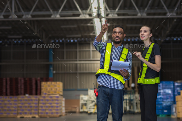 Warehouse worker working in warehouse storage. Stock Photo by kckate16