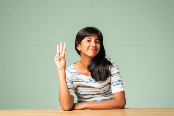 Asian Indian adorable little girl counting using fingers Stock Photo by ...
