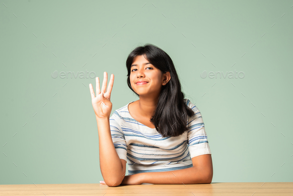 Asian Indian adorable little girl counting using fingers Stock Photo by ...