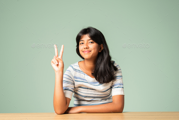 Asian Indian adorable little girl counting using fingers Stock Photo by ...