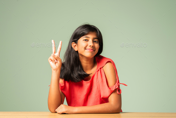 Asian Indian adorable little girl counting using fingers Stock Photo by ...