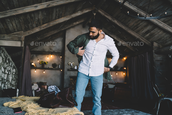 Stylish man putting on jacket Stock Photo by GaudiLab | PhotoDune
