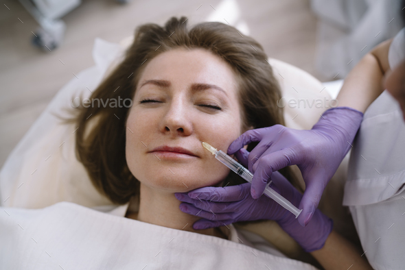 Female patient getting injection on face in professional clinic Stock ...