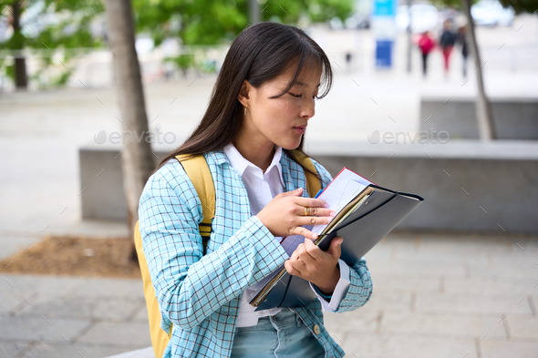chinese student reading notes at University campus Stock Photo by ...