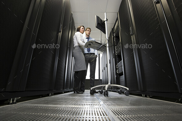Professionals troubleshooting in a data center server room Stock Photo ...