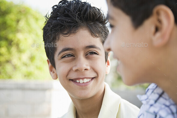 Two boys sharing a cheerful moment together Stock Photo by Image-Source