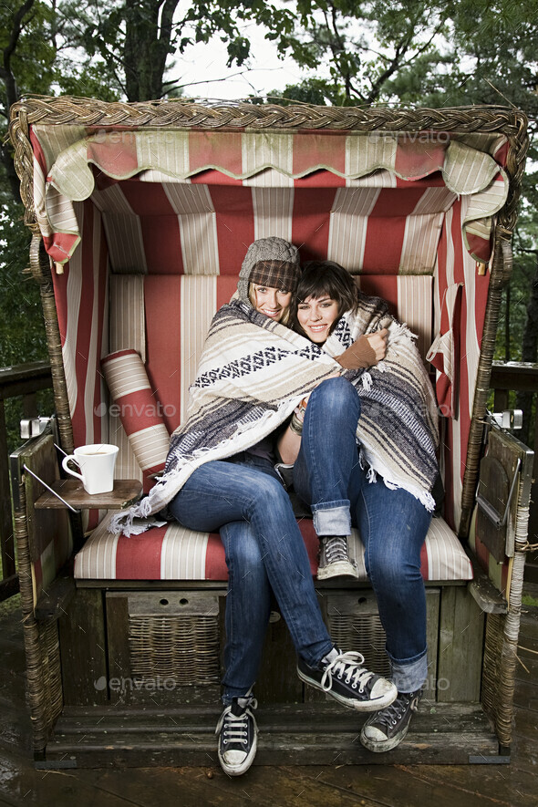 Female friends in beach chair Stock Photo by Image-Source | PhotoDune