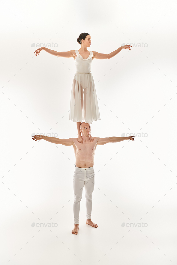 Man and Woman in Balancing Acrobatic Pose Stock Photo by LightFieldStudios