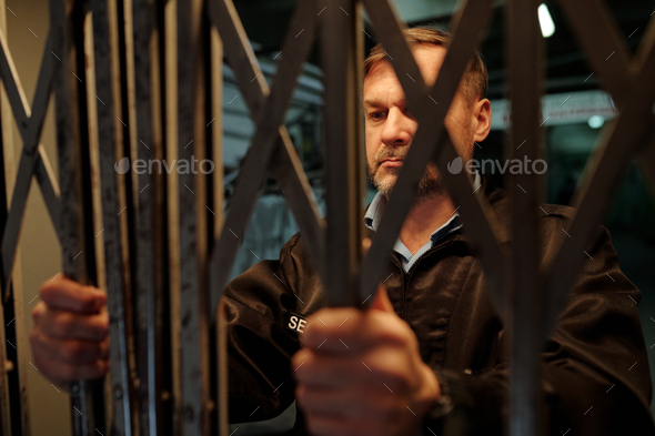 Security guard opening mesh gate Stock Photo by Pressmaster | PhotoDune