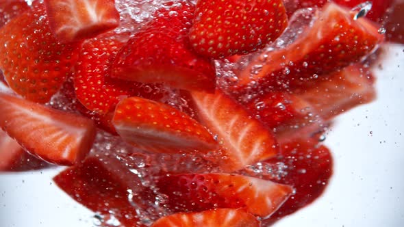 Super Slow Motion Shot of Fresh Strawberries Falling Into Water Vortex at 1000 Fps, Stock Footage
