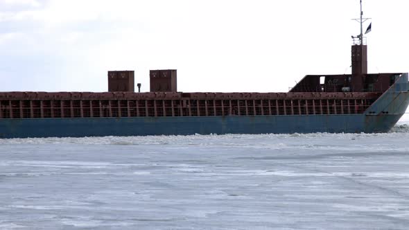 Cargo Ship Driving Through Frozen Sea Ice in Winter, Stock Footage
