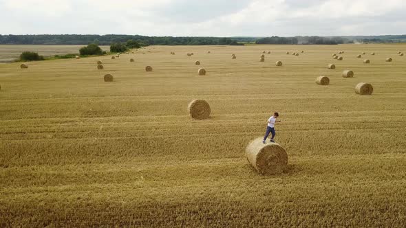 Child on a Field Against Straw, Stock Footage | VideoHive