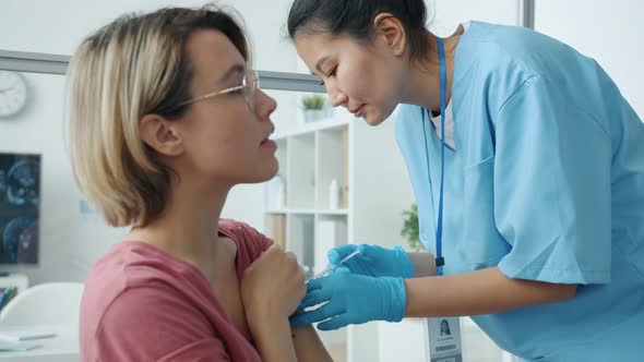 Nurse in Uniform Giving Covid19 Vaccine Injection to Serious Young Lady ...